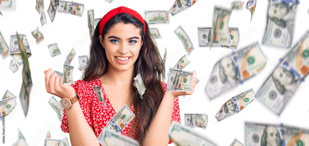 Brunette teenager girl wearing summer dress doing money gesture with ...