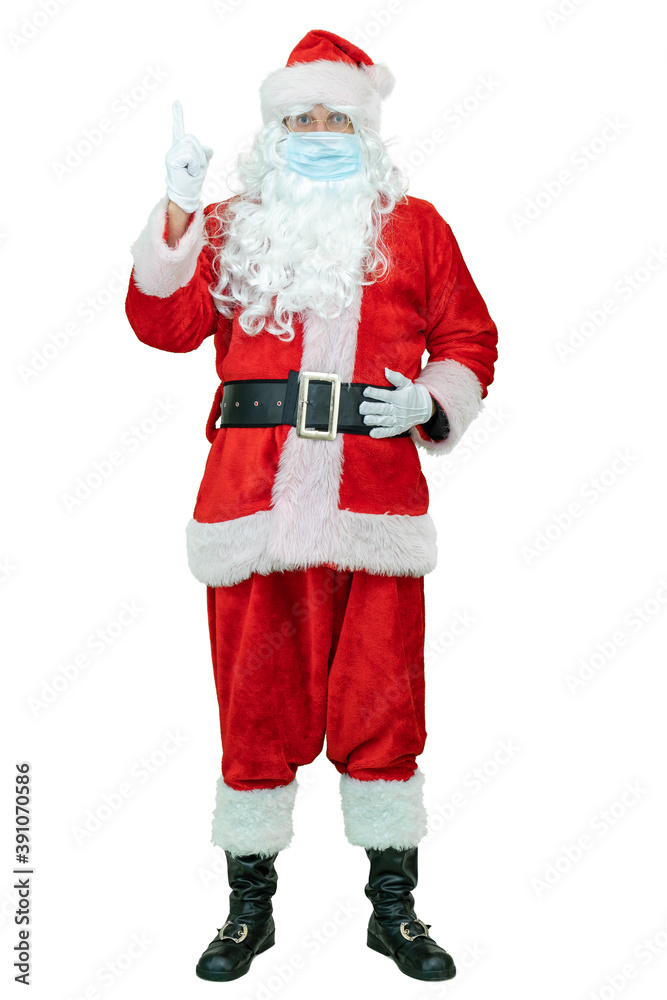 Santa wear in a covid medical mask, shows index finger up. Full body ...