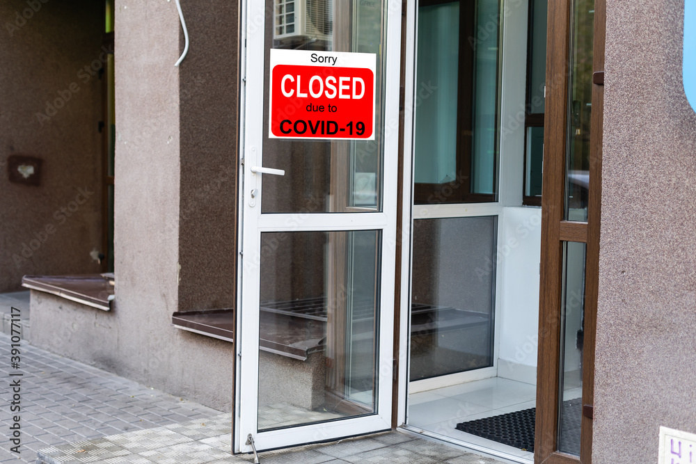 Close-up on a red closed sign in the window of a shop displaying the ...