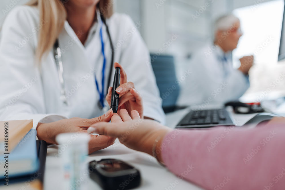 Doctor checking blood sugar level with glucometer of overweight woman ...