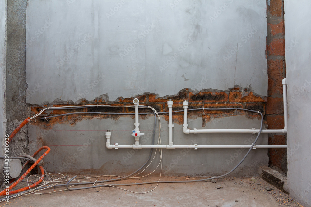 Water supply system installation. Laying pipes in the wall. Cold and ...