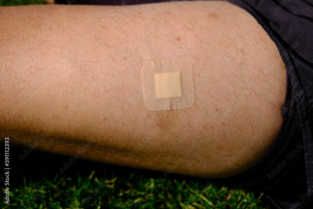 apply a plaster to the wound on the leg. wound care. first aid after a ...