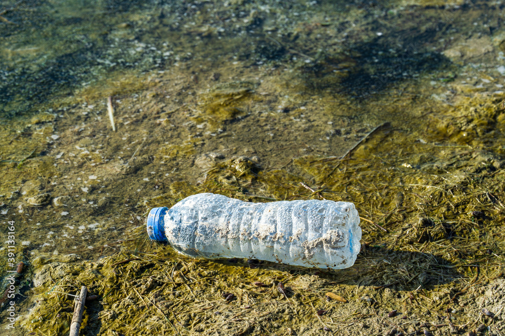 Plastic garbage in the lake , pollution and environment concept. A ...