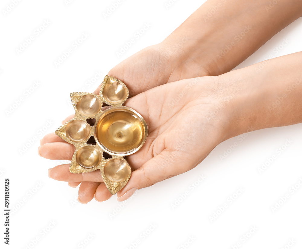Female hands with diya lamp for celebration of Divaly on white ...