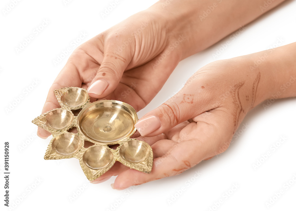 Female hands with diya lamp for celebration of Divaly on white ...