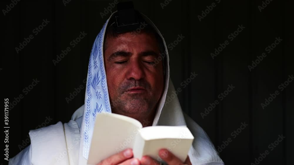 Adult Jewish man praying with with Tallit (prayer shawl) and Tefillin ...