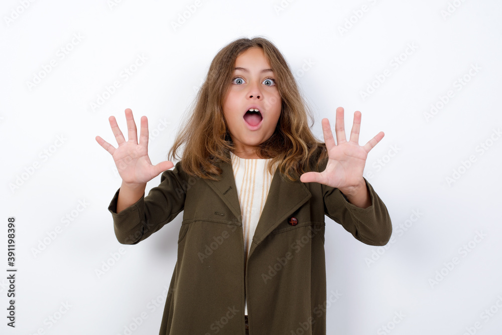 Dissatisfied Beautiful little girl standing against white background ...