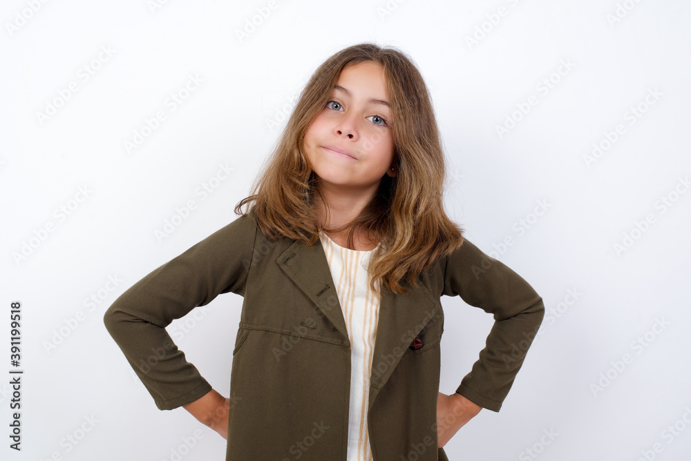 Funny frustrated Beautiful little girl standing against white ...