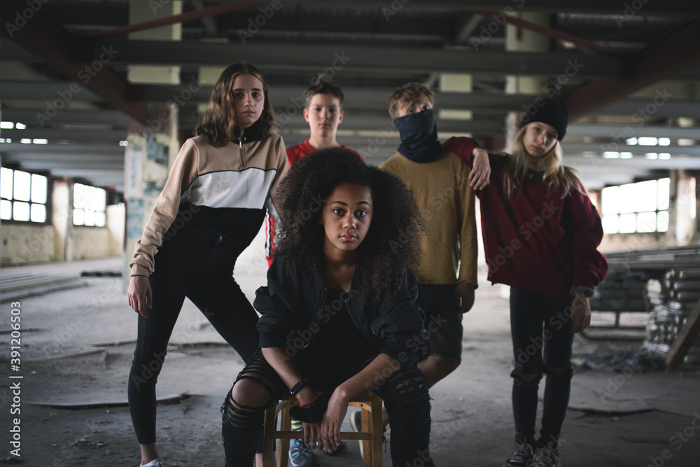 Group of teenagers gang standing indoors in abandoned building ...