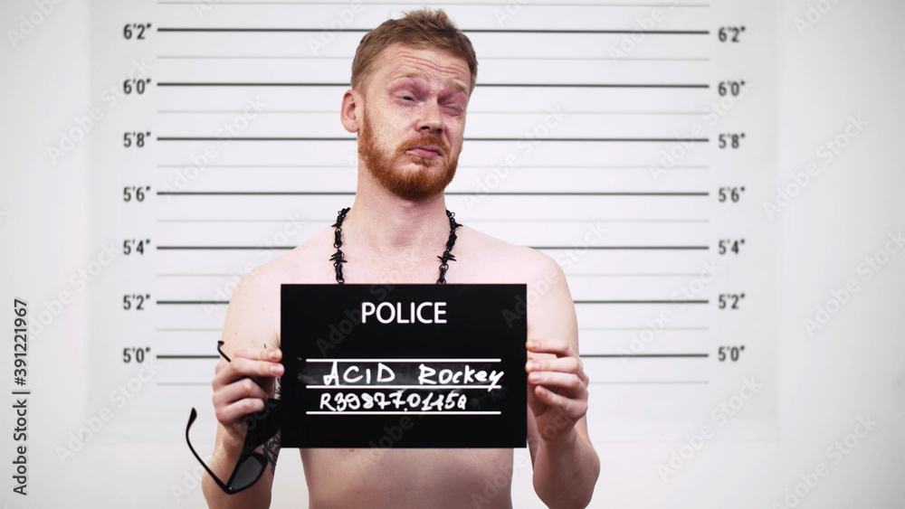 Stockfoto Male prisoner with bare chest posing for police mugshot at ...