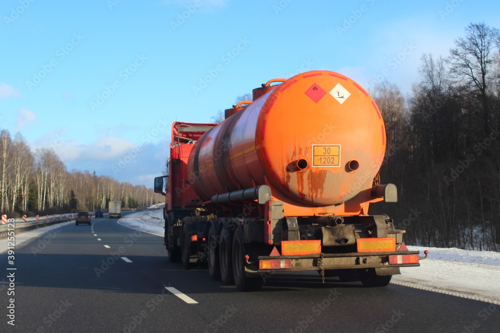 Fotka „Orange semi truck fuel tanker with 30 1202 dangerous class sign ...