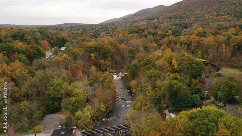 An aerial shot of the colorful fall foliage in upstate NY. The camera ...