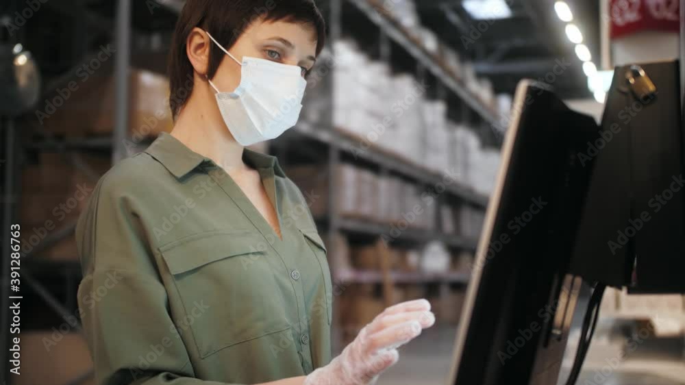 Female worker of logistic warehouse working by touch screen display of ...