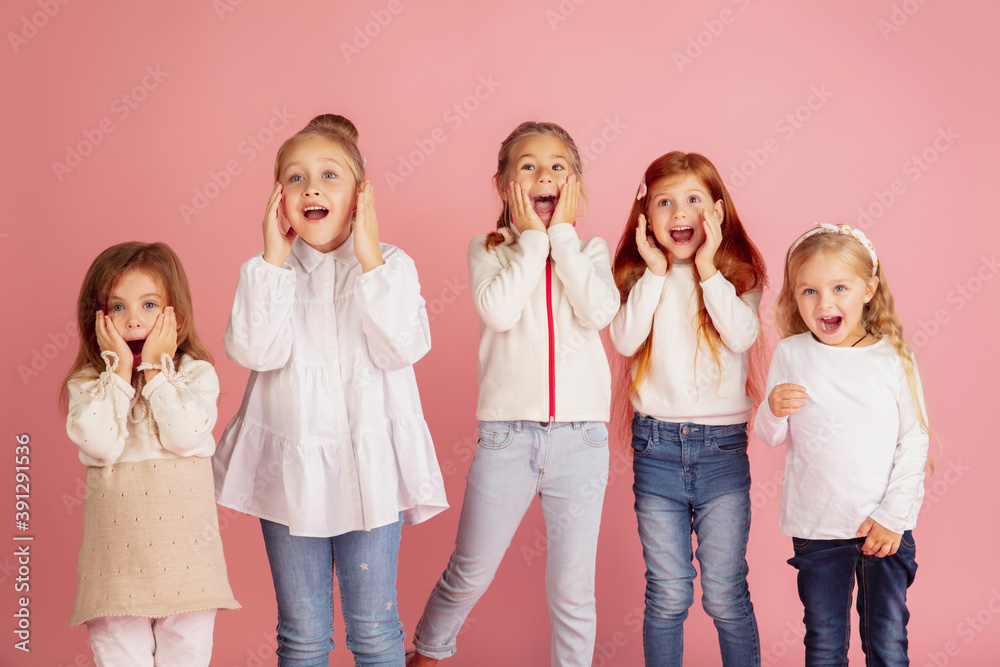 Astonished, laughting. Portrait of little caucasian children isolated ...