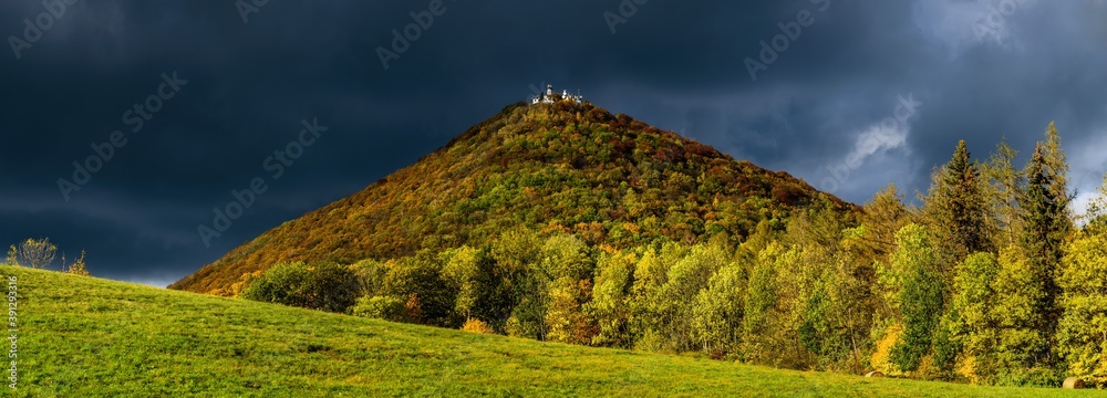 A dark stormy cloud above the hill Milesovka. Milesovka is the highest ...
