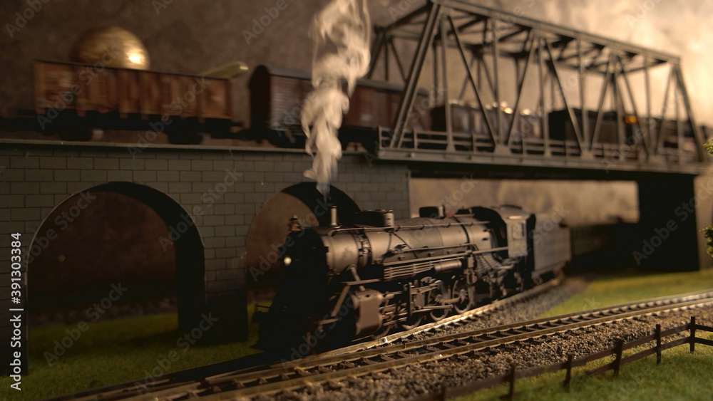 Lokomotive with steam smoke. Retro miniature railway model. Stock Photo ...