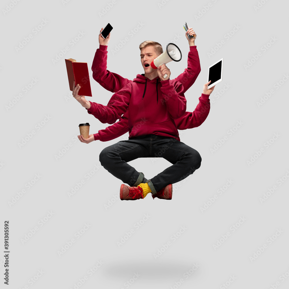 Handsome student, multi-armed man levitating isolated on grey studio ...