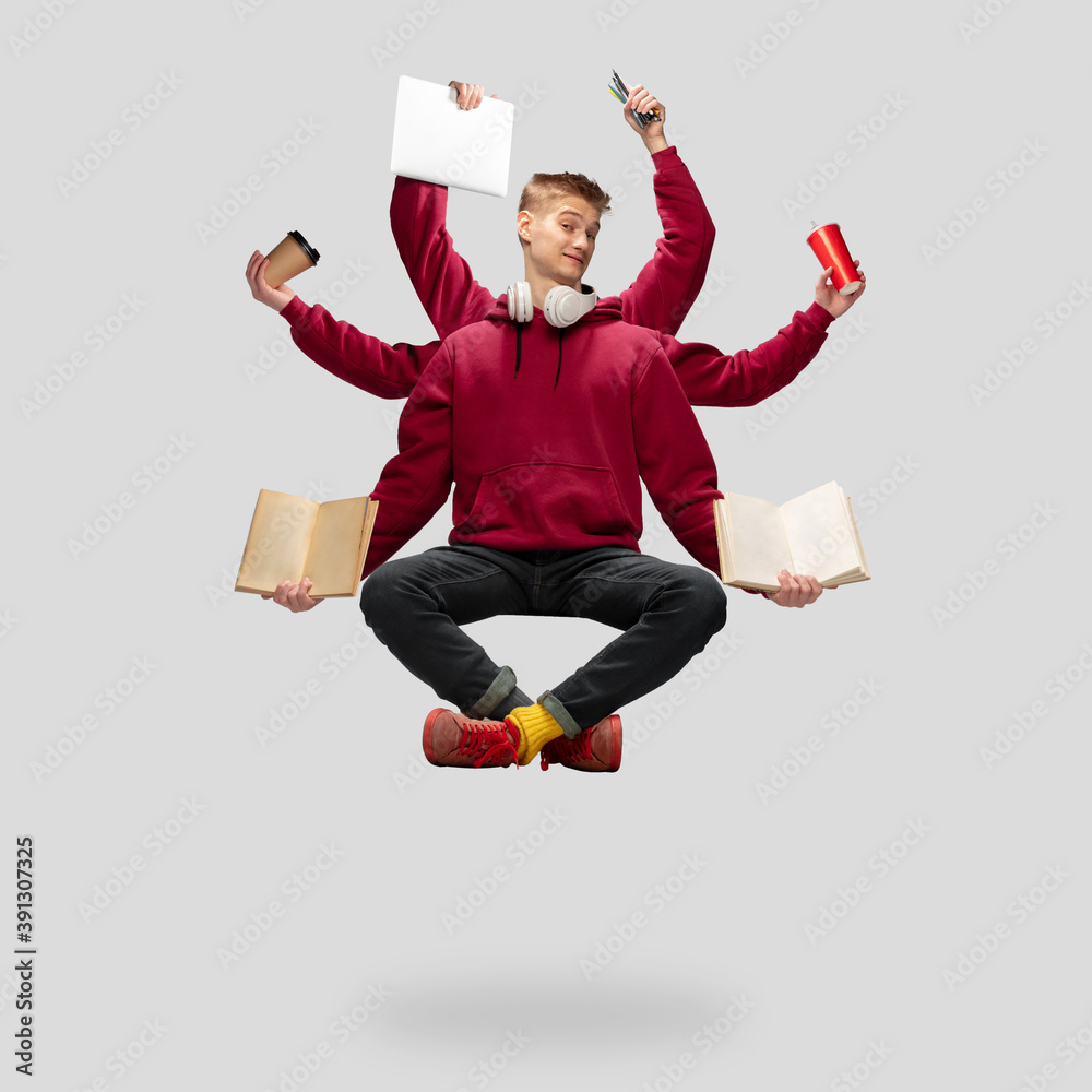 Handsome student, multi-armed man levitating isolated on grey studio ...