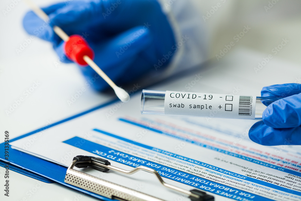 Medical worker holding Coronavirus COVID-19 NP OP swab sample test kit ...