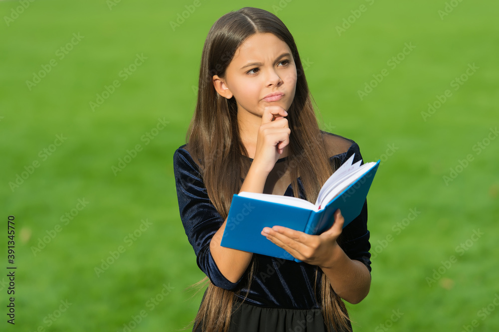 Think clearly and rationally. Serious child think holding book green ...