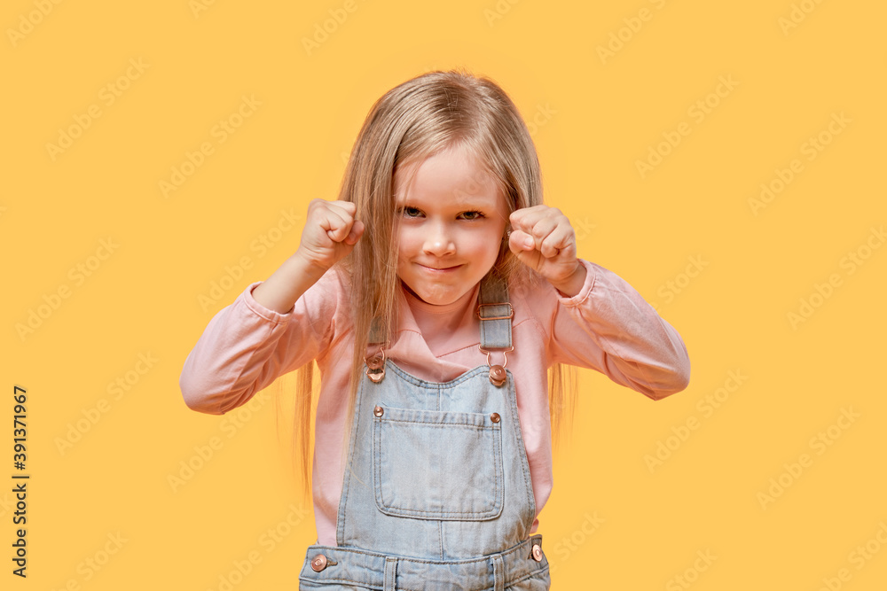 An angry girl looks at the camera with an angry expression on her face ...