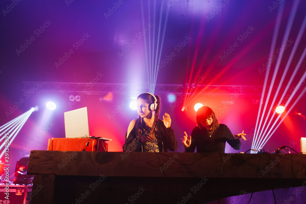 Young DJ women playing music at a party Stock Photo | Adobe Stock