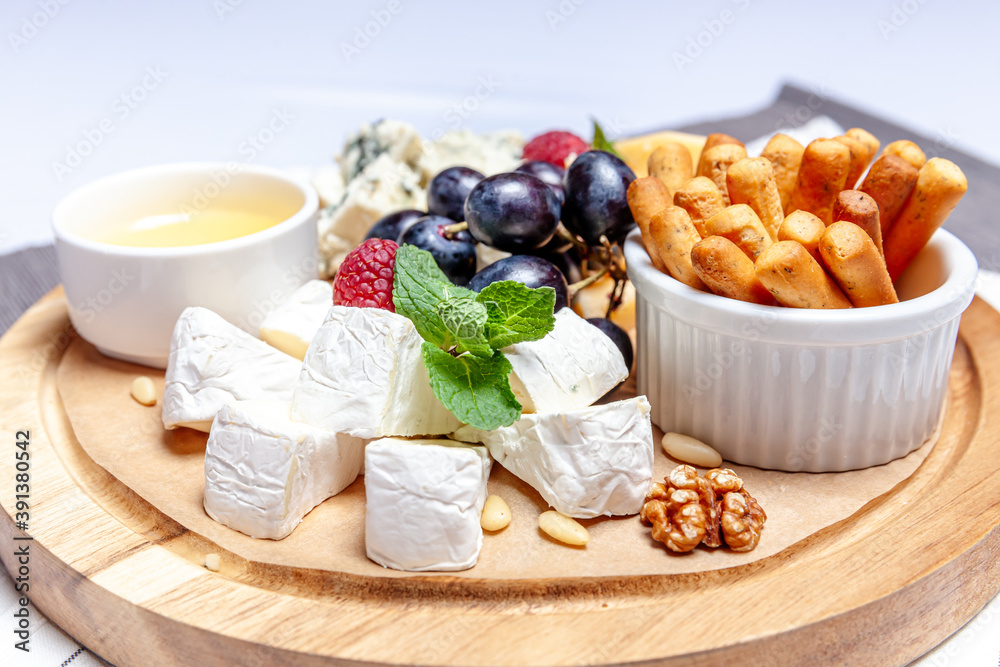 Board with different types of cheese. Cheeses mix set dor blu chedar ...