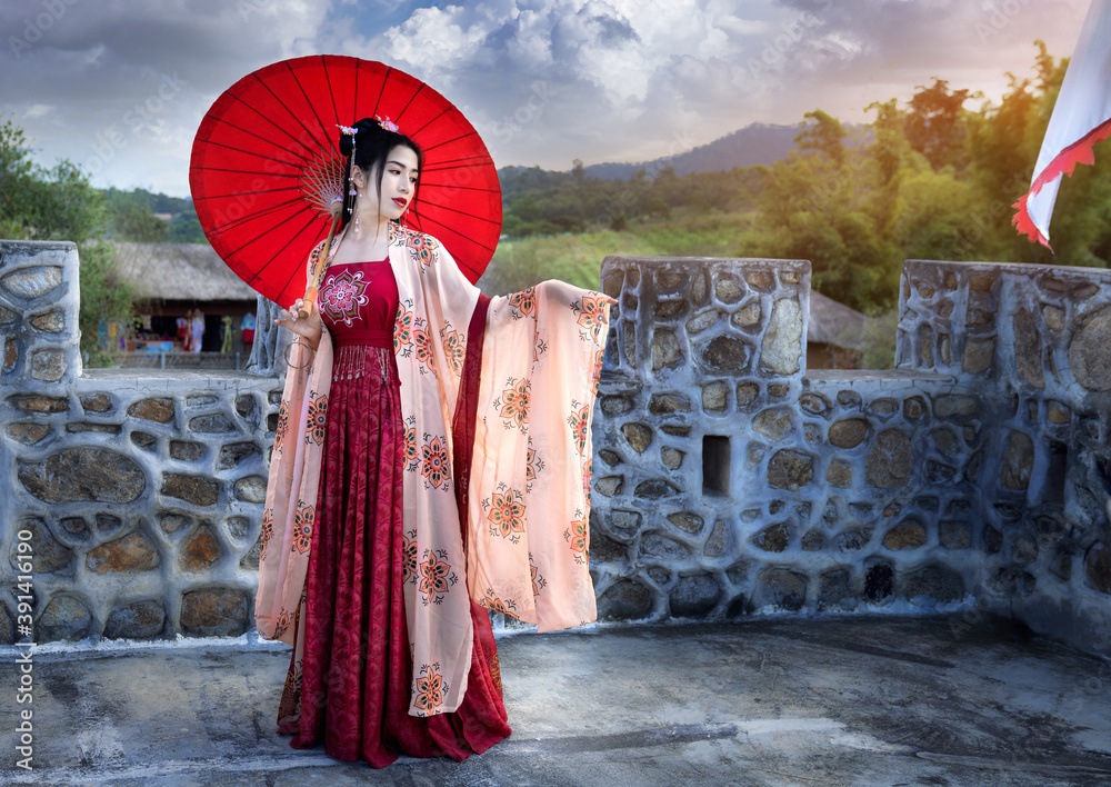Asian woman wearing a red Chinese culture dress visit Santichon Village ...