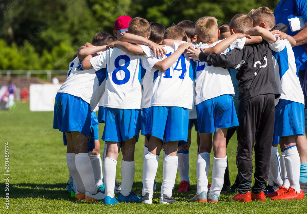 Coach with children soccer team. Kids in white and blue soccer uniforms ...