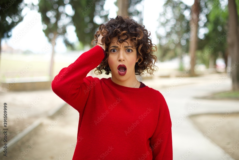 Embarrassed attractive Young beautiful Arab woman standing outdoors ...