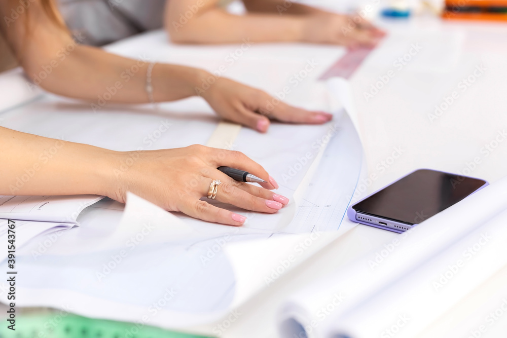 Fashion designer's hands. Closeup of hands drafting a new sewing ...