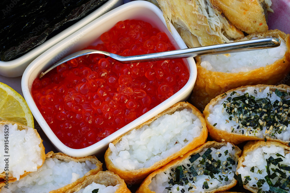 Inari rolls, tofu skins stuffed with sushi rice, with ikura salmon roe ...