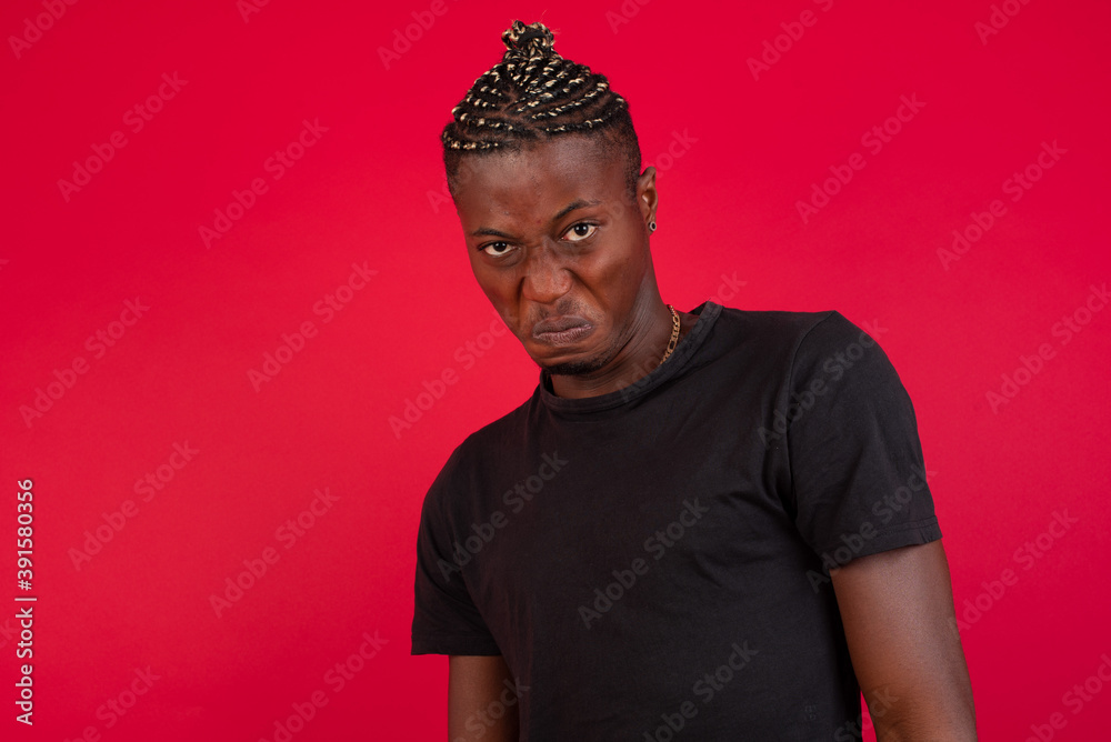 Young African American handsome man standing against red background ...