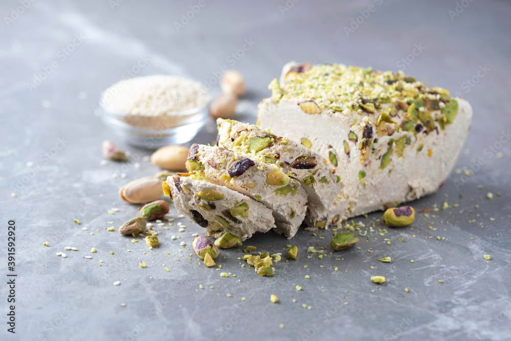 Sesame halva with pistachios on grey background. Top view. Copy space ...