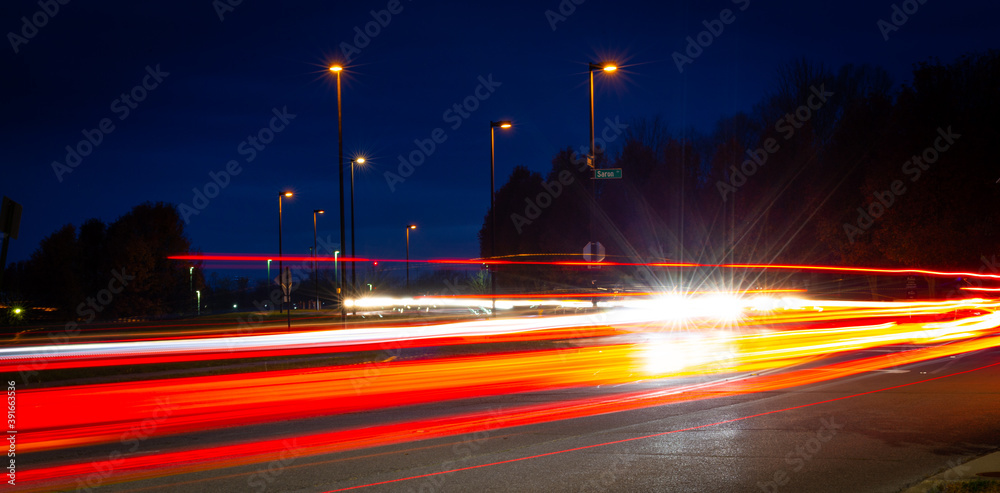 Long exposure shot of the traffic with the red tail lights making rays ...