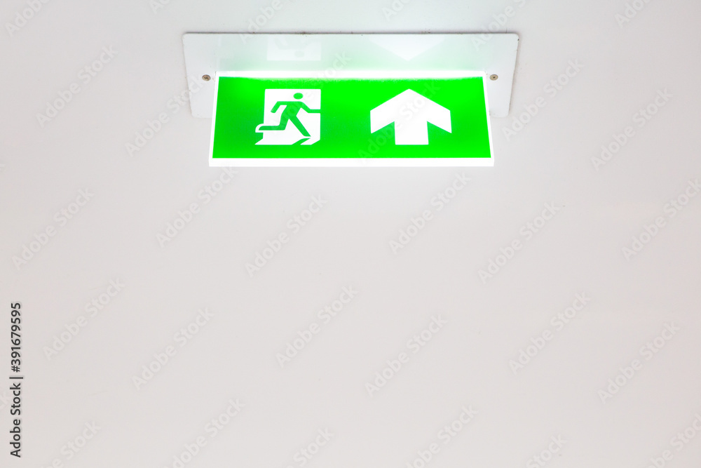 Emergency exit signboard on white ceiling background and copy space ...