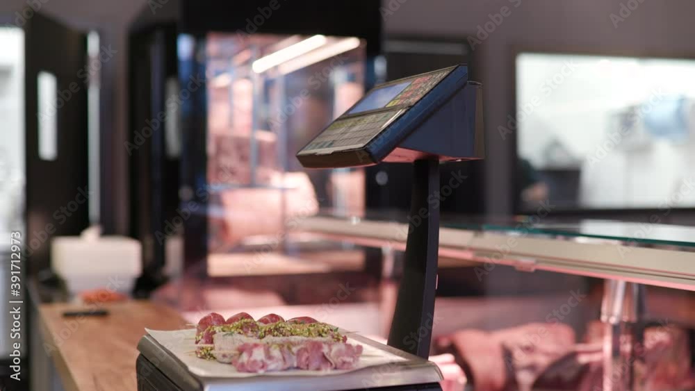 Close up of six beautiful meat skewers in a butcher shop. Man at work ...