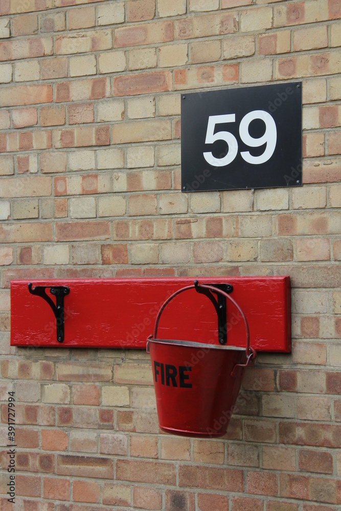 red painted FIRE buckets at point 59 information sign on traditional ...
