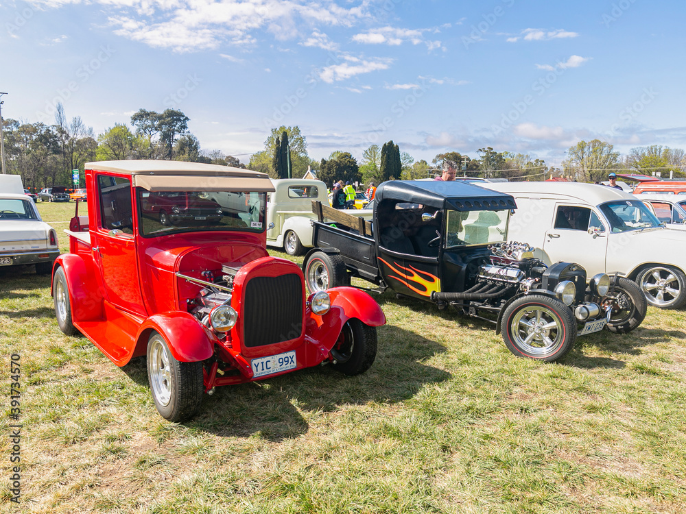 Side view of restored and rebuilt classic red and black hot rod cars ...