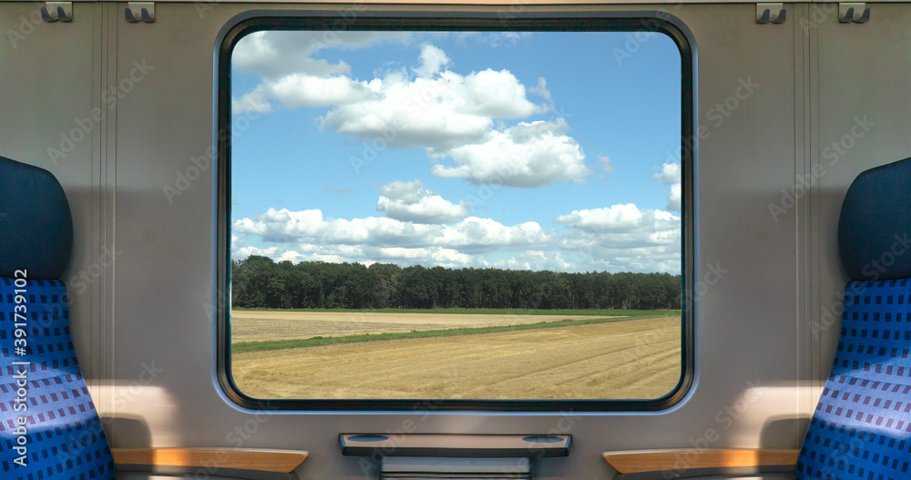 An empty blue seat in europe german train with window corn field ...