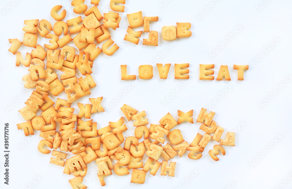 Heap of biscuit or cracker ABC letter alphabet with text LOVE EAT ...