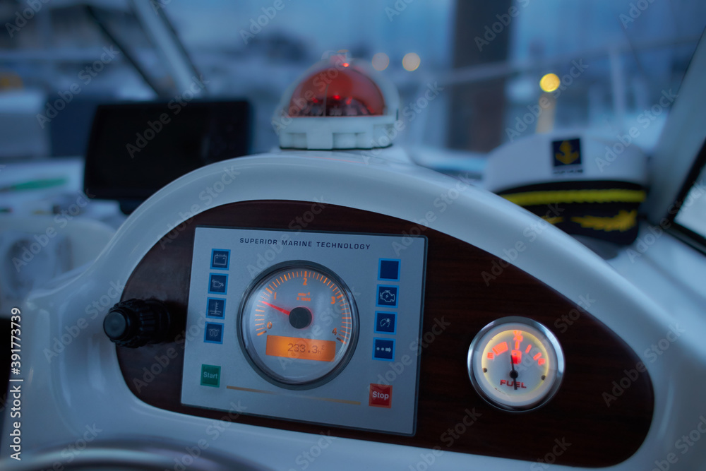 A big compass on a boat showing direction and wood steering wheel in ...