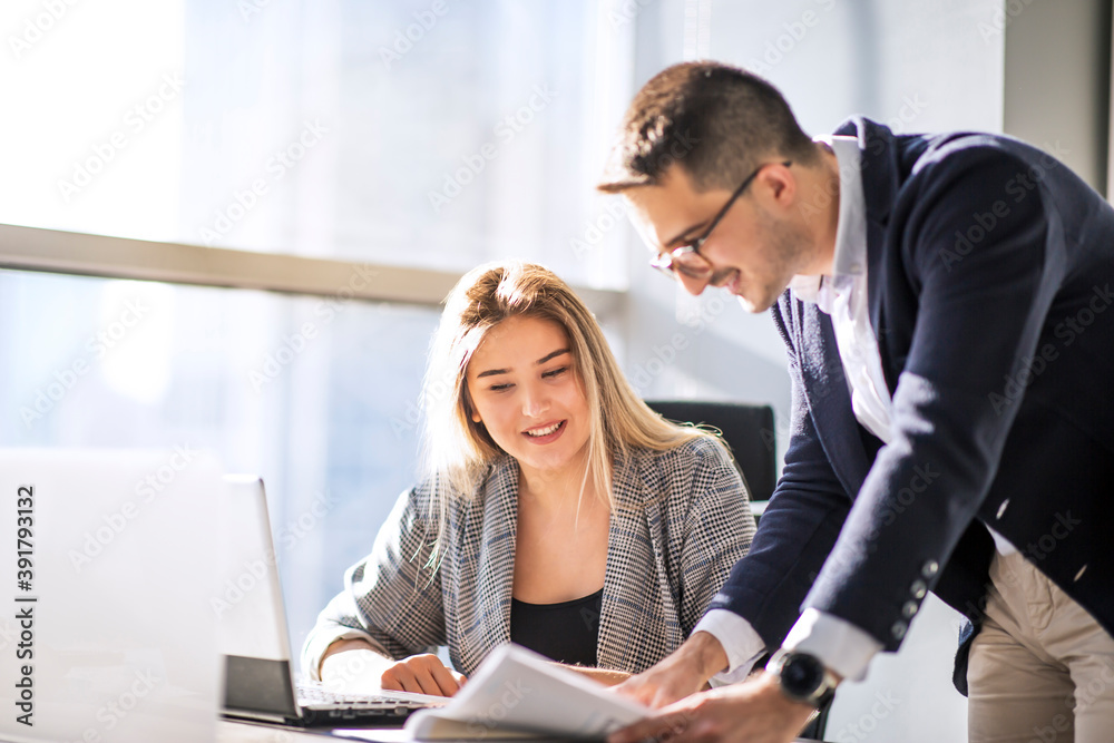 Man manager and woman data analyst working with together in a modern ...