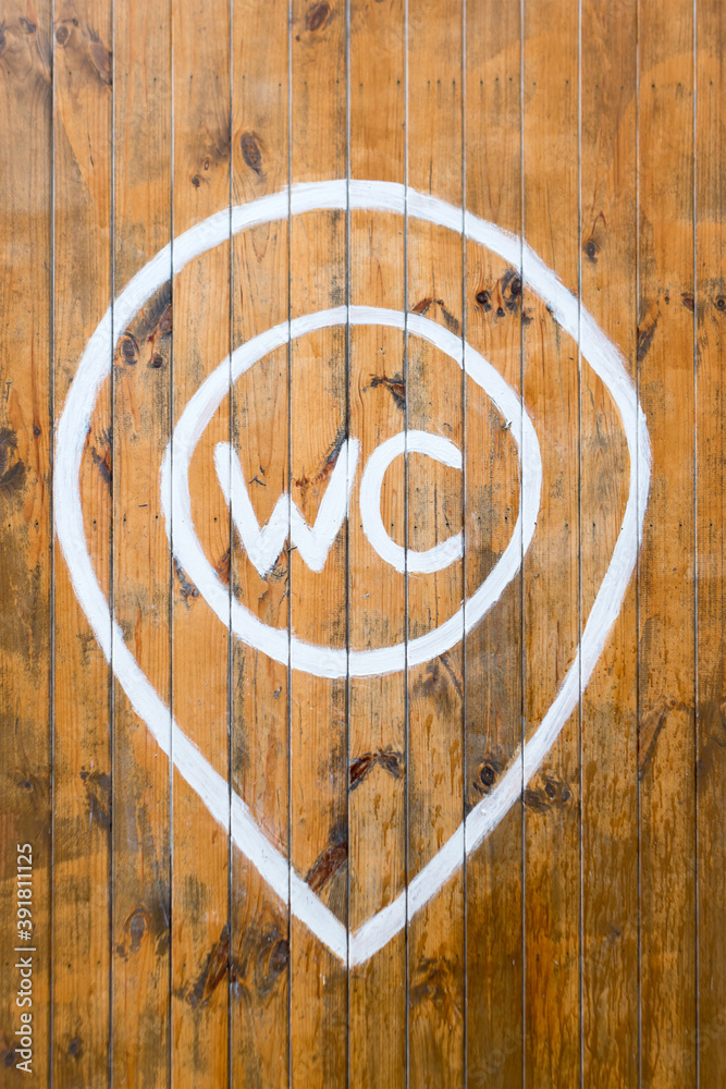 WC sign with white painted text on wooden wall Stock Photo | Adobe Stock