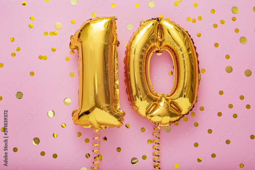 10 air balloon numbers on pink background. 10 k gold foil balloons with ...