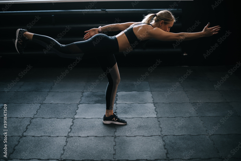 Fitness young woman with perfect athletic body wearing black sportswear ...