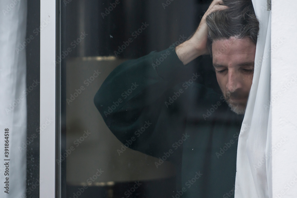 dramatic portrait of attractive sad and depressed mid adult man looking ...