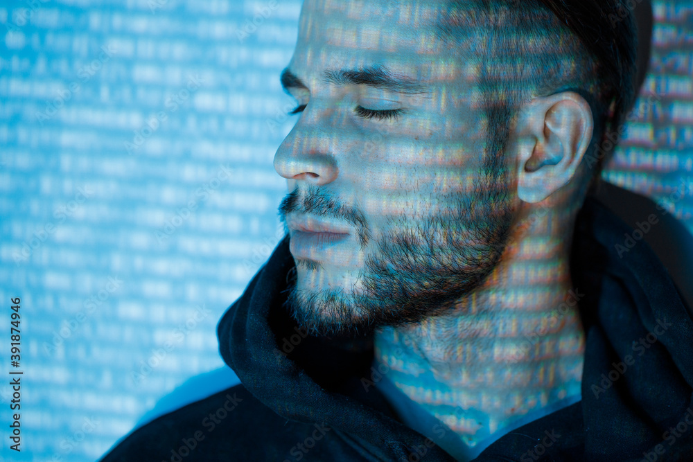 Portrait of hacker man on blue neon light background. Internet ...
