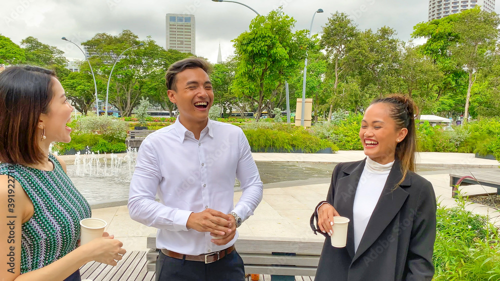 Outdoor business meeting. One asian man and two asian women talking ...