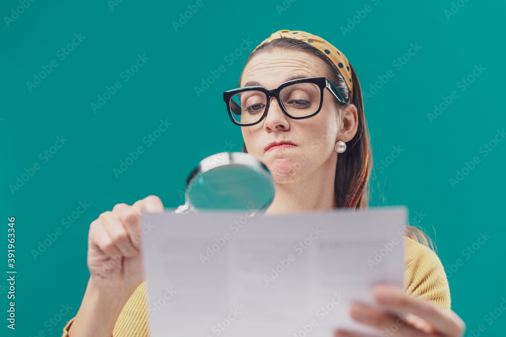 Woman checking carefully a document using a magnifier Stock Photo ...